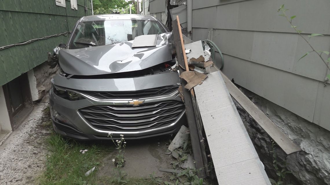 Residents wake up to find a car wedged between 2 homes | wgrz.com