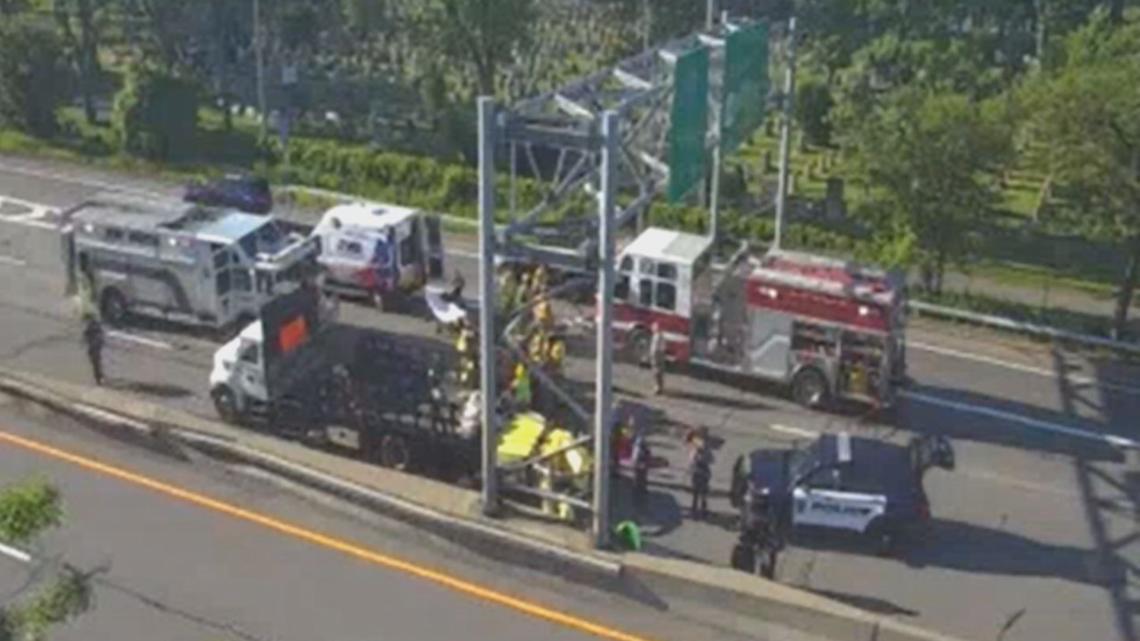 Car pinned under construction vehicle after rear-end collision, forcing ...