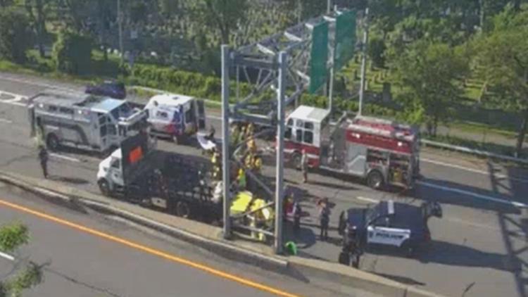 Car pinned under construction vehicle after rear-end collision, forcing ...